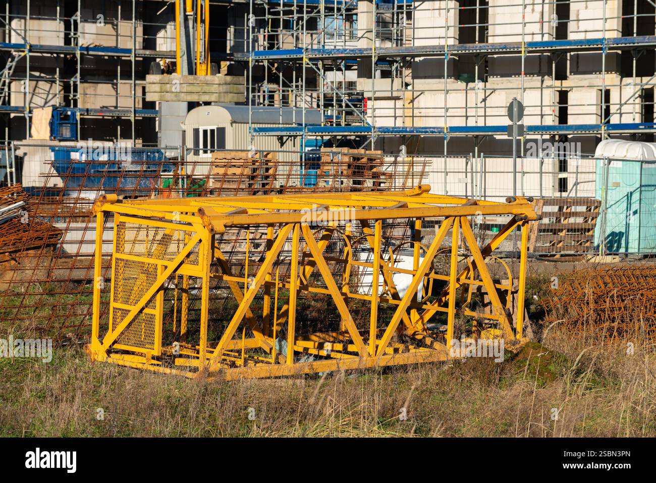 A busy construction site features scaffolding and various building ...