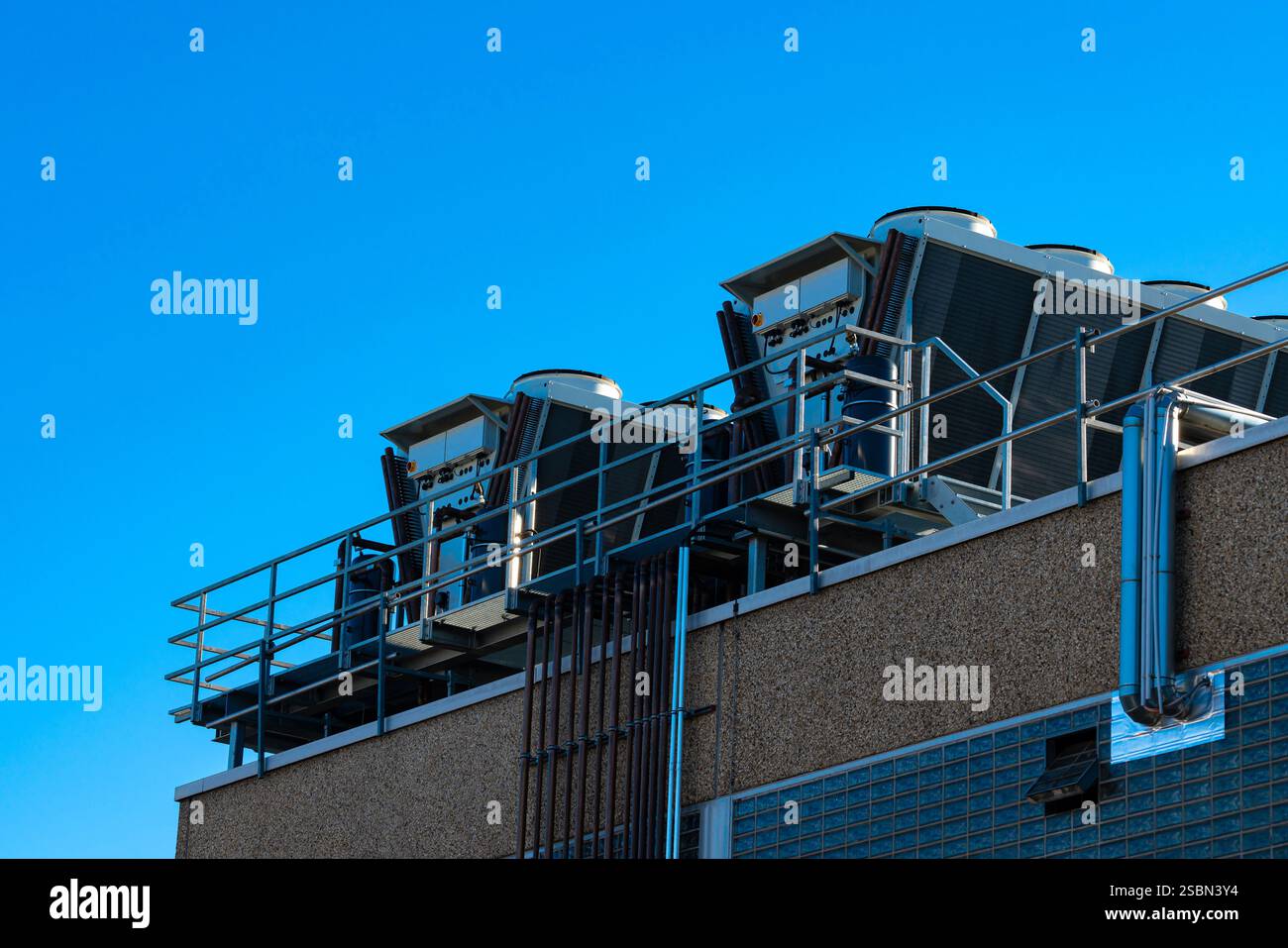 Large air conditioning units are installed on the rooftop of a modern ...