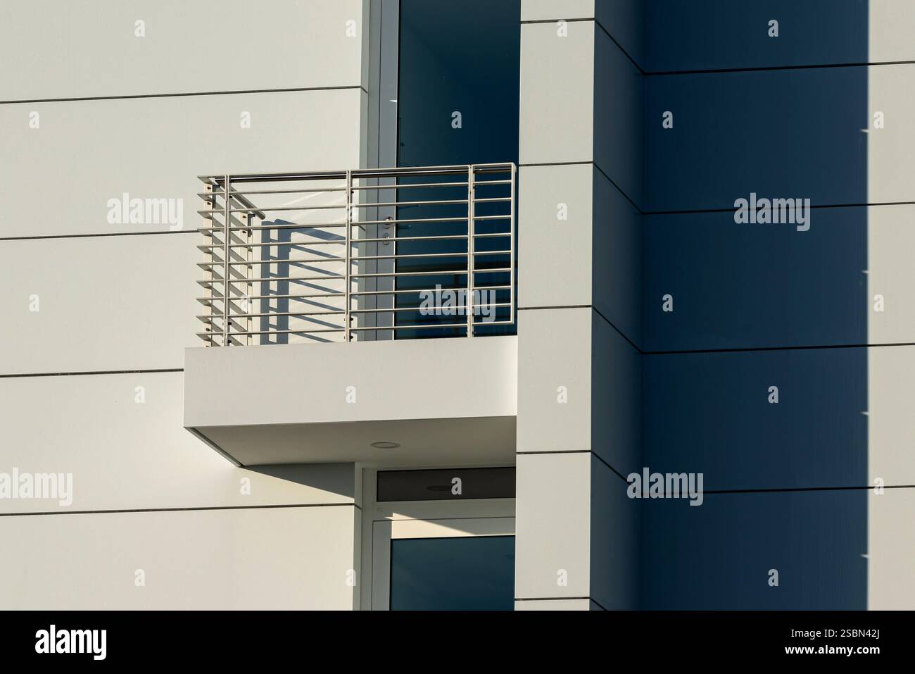 The image captures a modern balcony featuring a minimalist railing ...