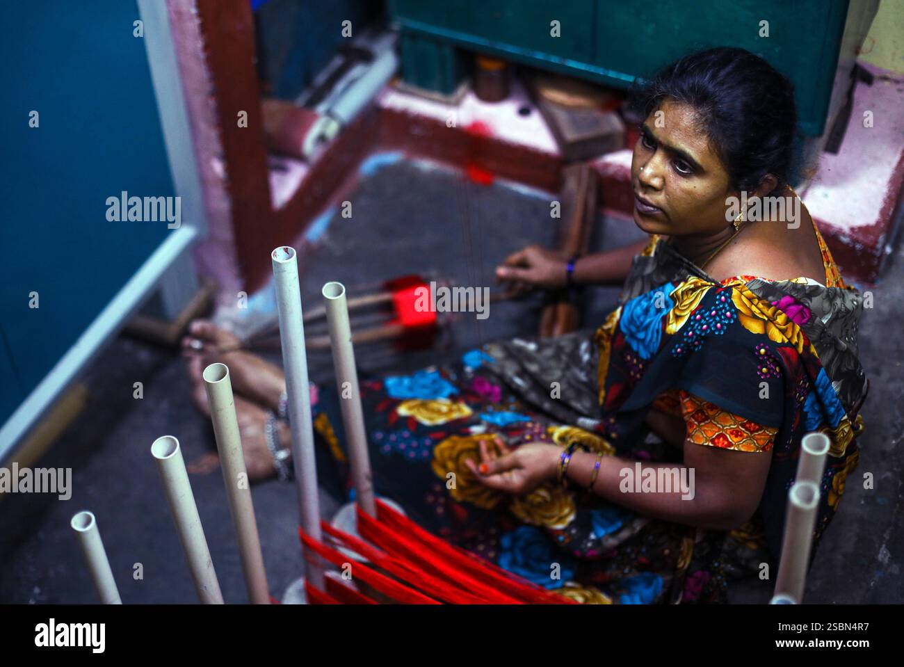 Kanchipuram Sari of India A weaver softens the silk threads before ...