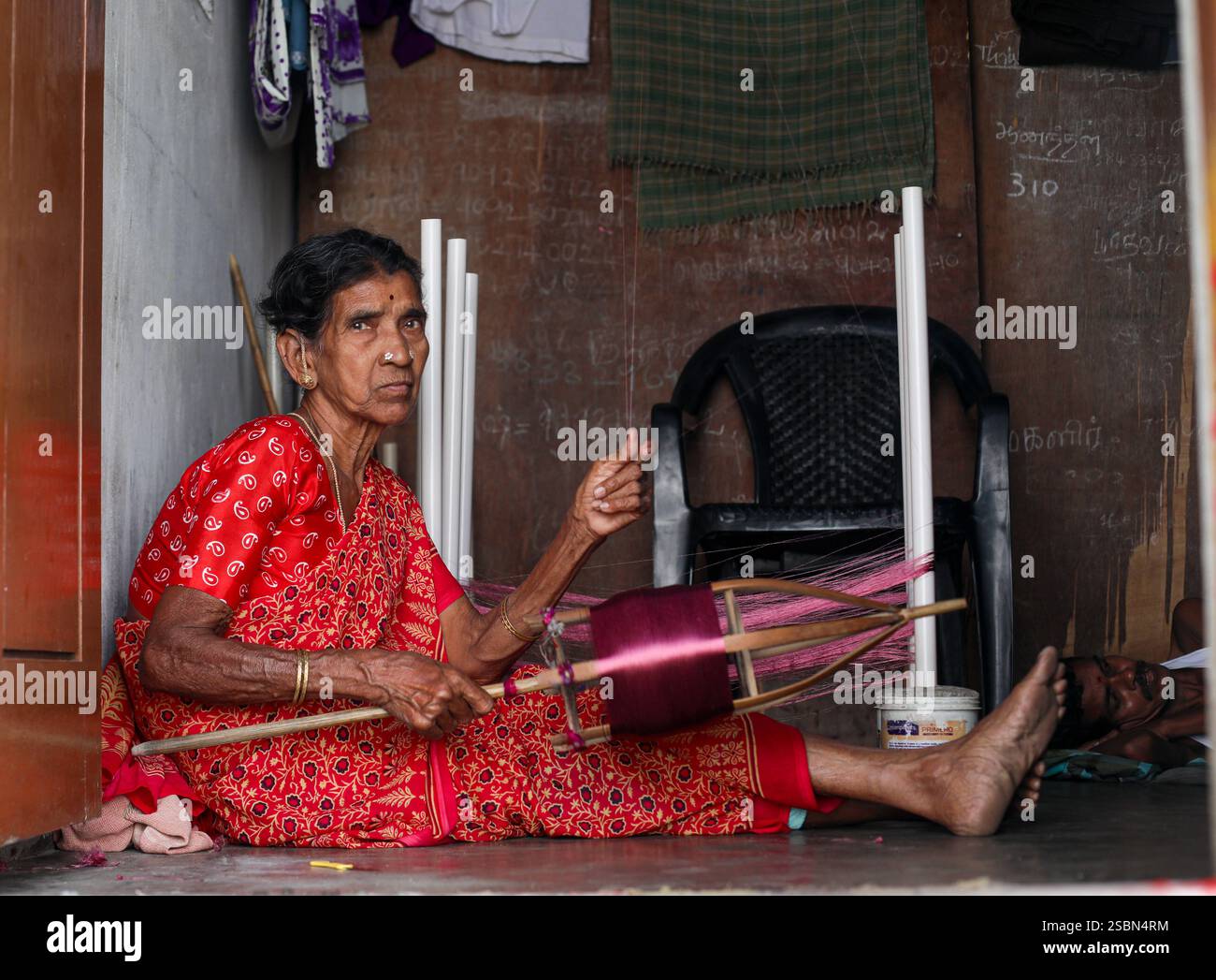 Kanchipuram Sari of India A weaver prepares the silk threads for the ...