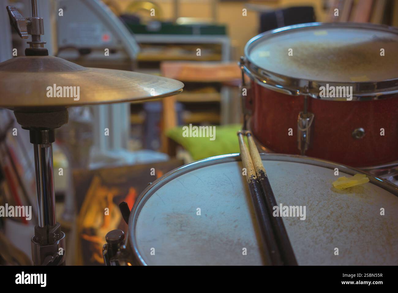 Old drum set close up, red timpani and snare with sticks, hardware ...