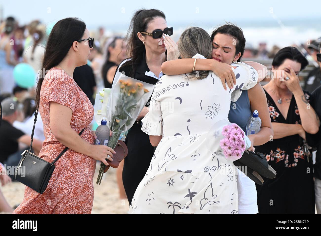 People are seen during a vigil for shark attack victim Charlize Zmuda ...