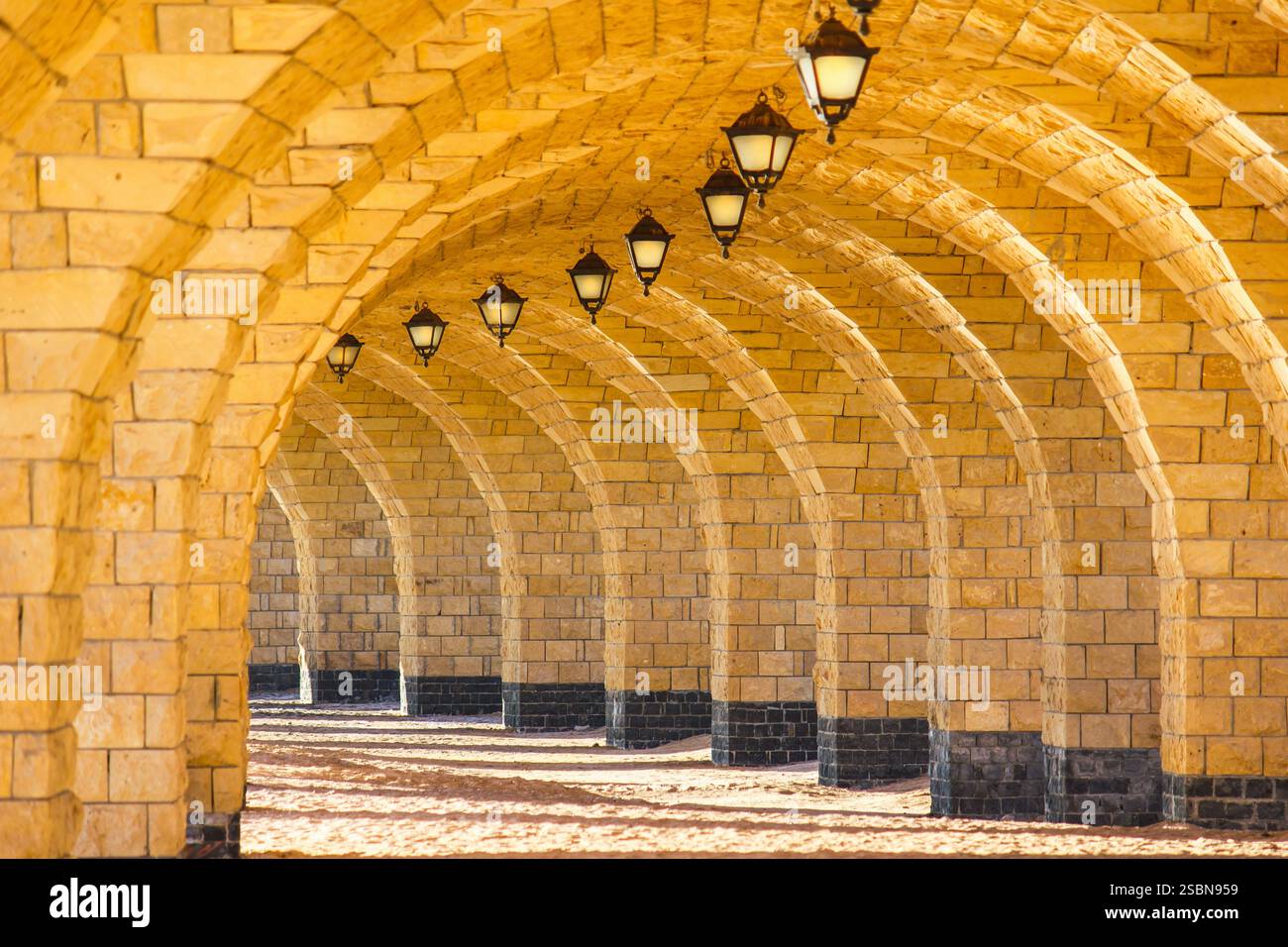 The arched stone colonnade with suspended lanterns Stock Photo - Alamy