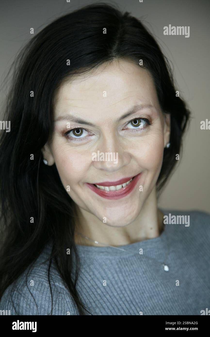 Smiling brunette woman middle aged 51 years old in red long silk skirt ...