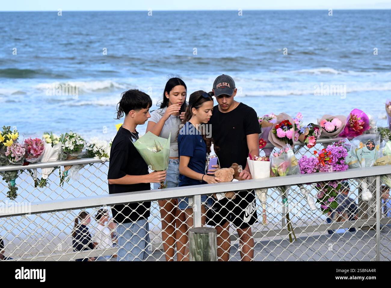 People are seen during a vigil for shark attack victim Charlize Zmuda ...