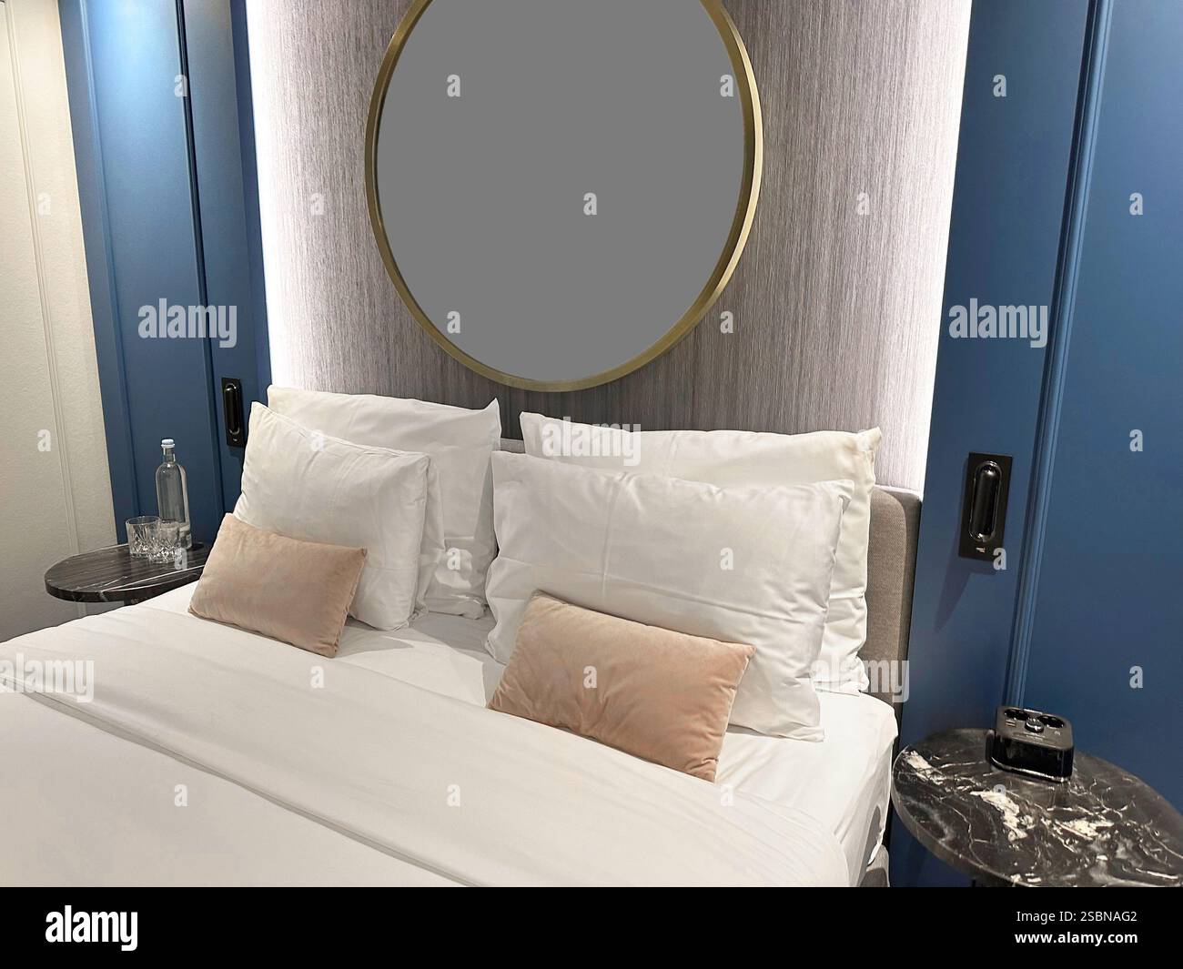 Comfortable bed with clean linens in hotel room Stock Photo - Alamy