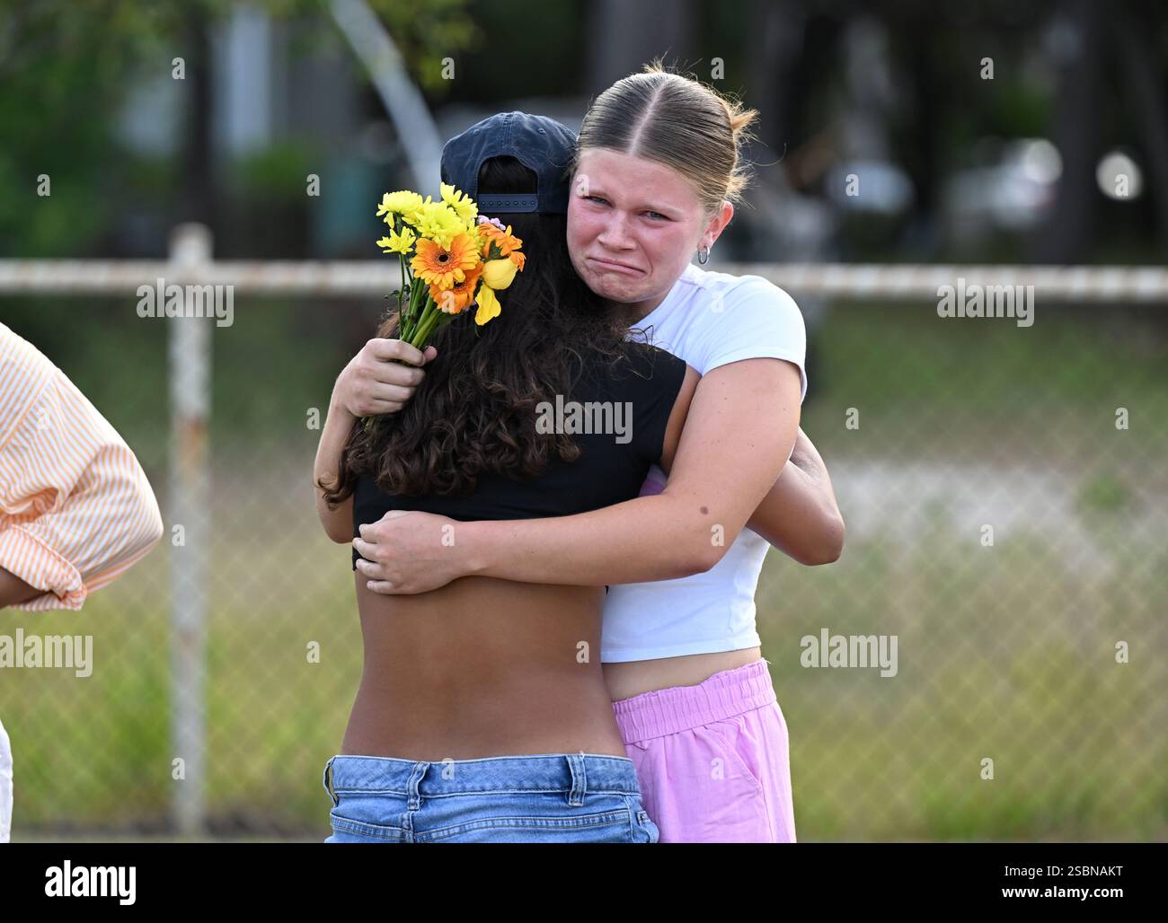 People are seen during a vigil for shark attack victim Charlize Zmuda ...