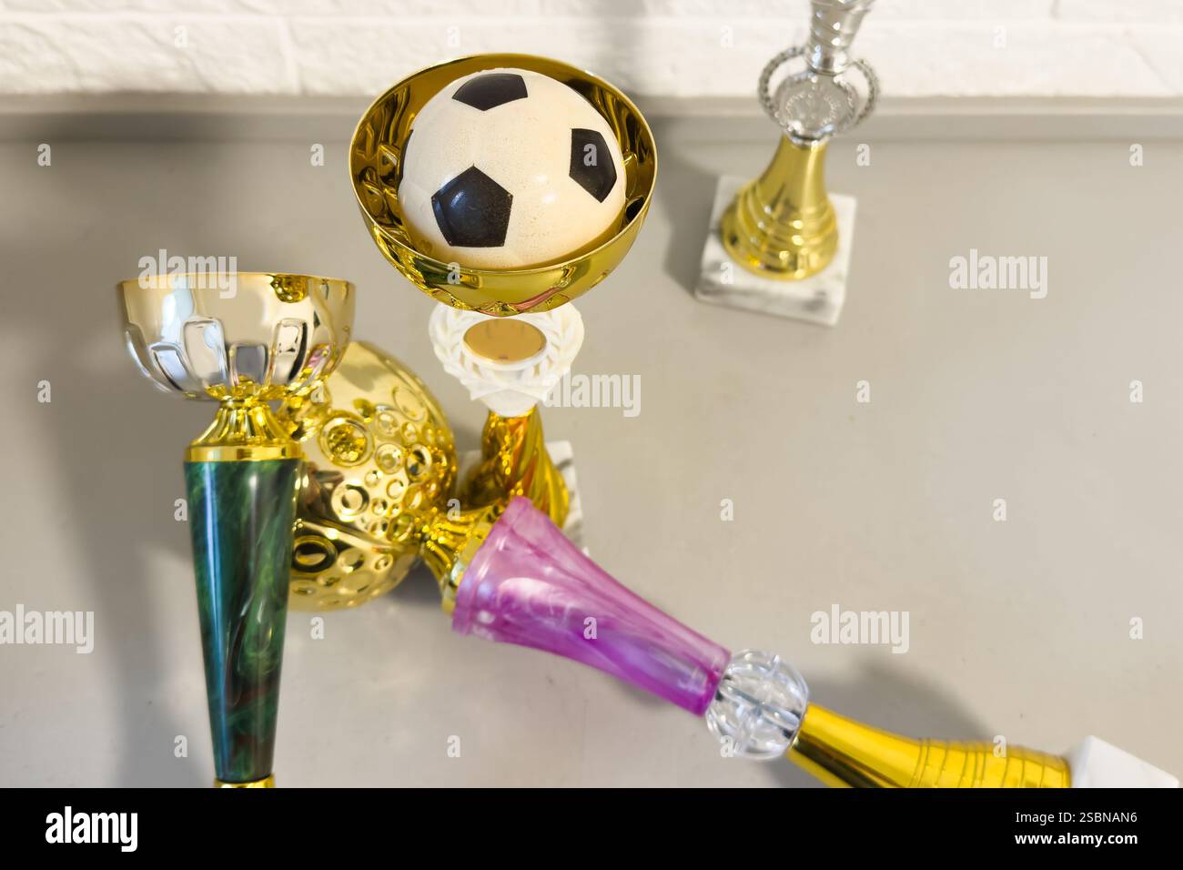 Cups of winners award, Sport equipment and balls Stock Photo - Alamy