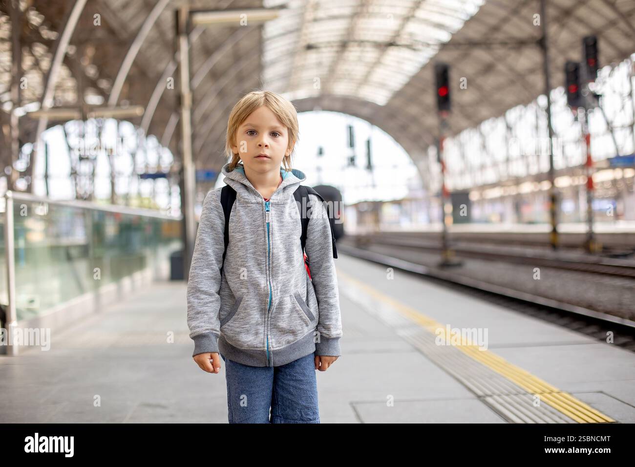 Cute preschool child with backpack, running for the train on a ...