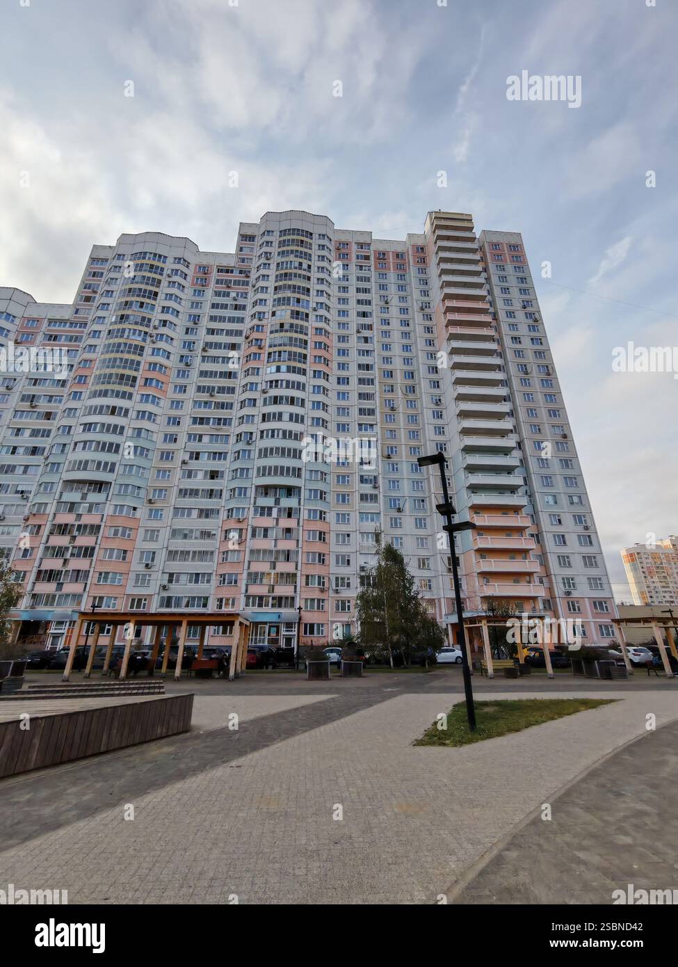 A large multi-story residential building with a pastel color palette of ...
