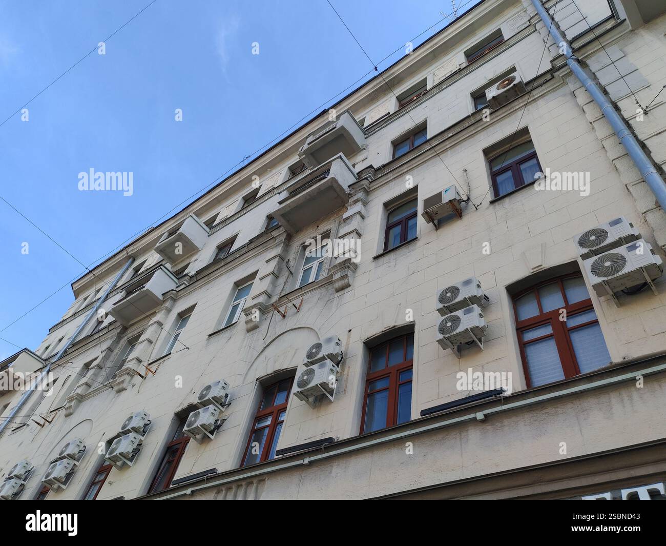 large yellow building with multiple windows and an arched doorway ...