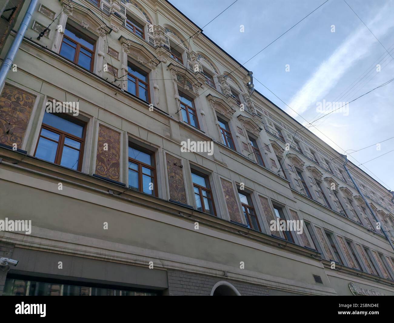 large yellow building with multiple windows and an arched doorway ...