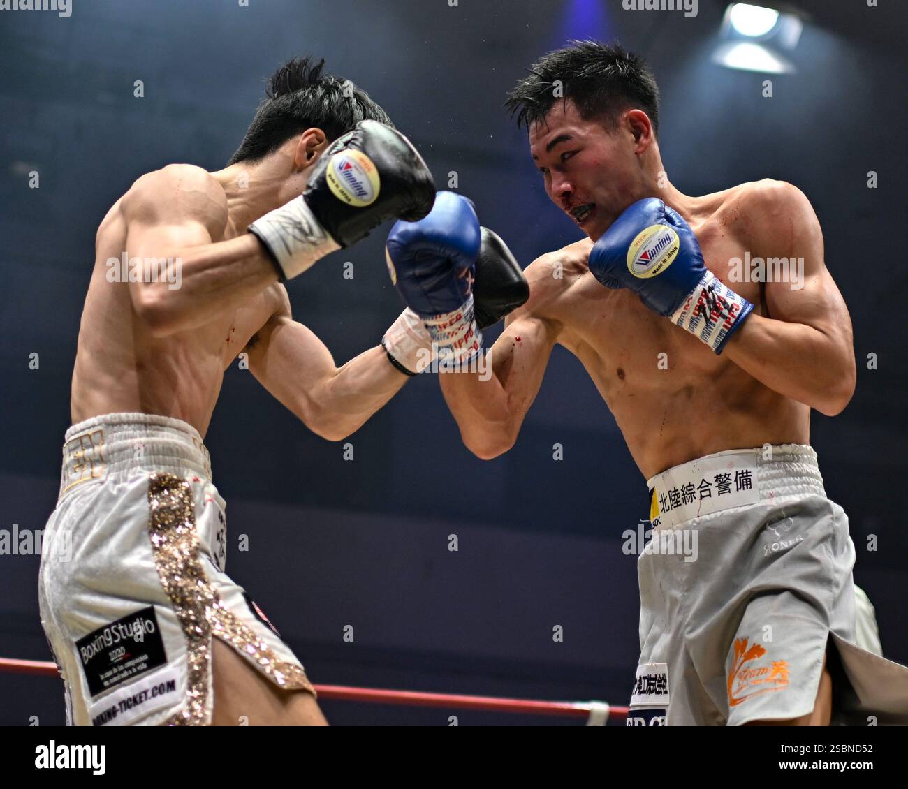 Tokyo, Japan. 18th Jan, 2025. Challenger Hiroki Hanabusa (blue gloves) throws a right at ...