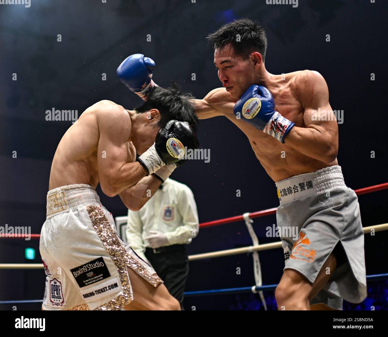 Tokyo, Japan. 18th Jan, 2025. Challenger Hiroki Hanabusa (blue gloves) throws a right at ...