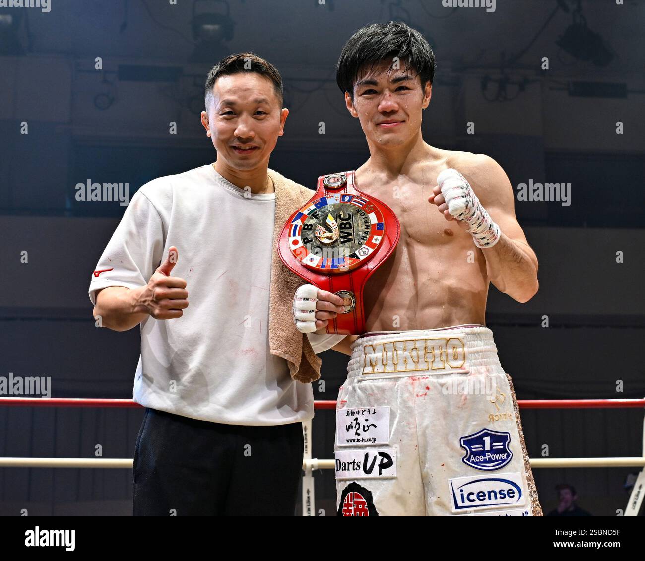 Champion Mikito Nakano, right, poses with trainer Takahiro Aou after ...