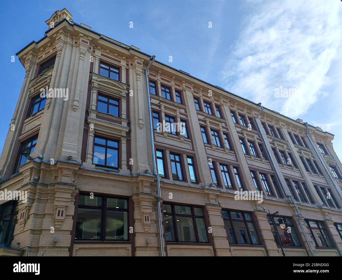 An elegant historic building with intricate brickwork and large windows ...