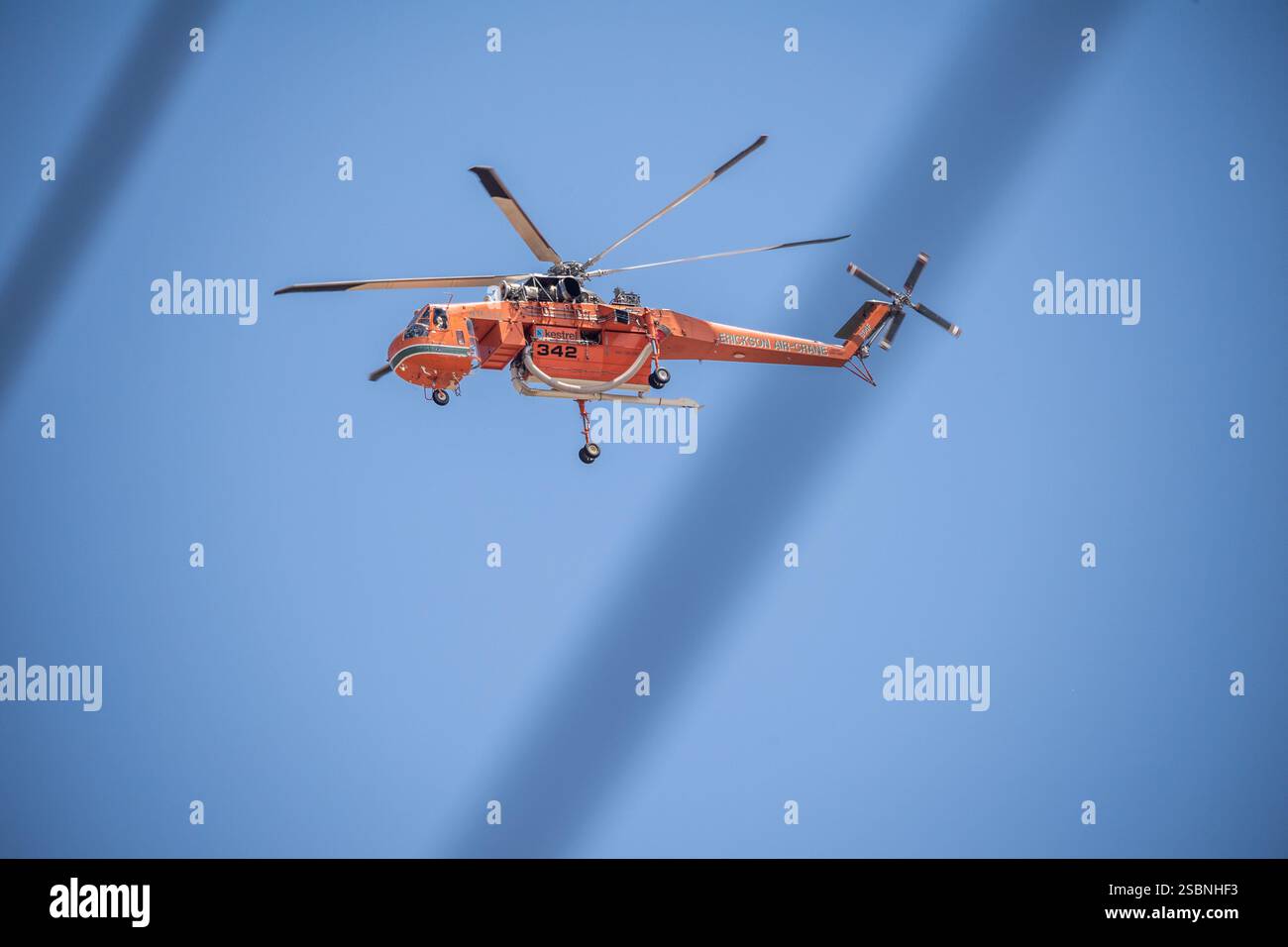 A firefighting helicopter returns from the fire zone, after aiding ...