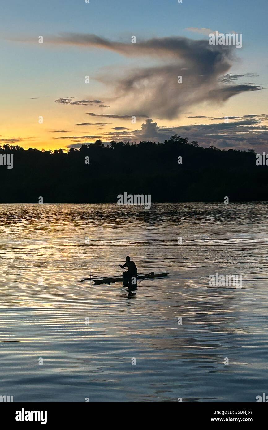 Residents of Tungelo Island in their traditional dugout canoes at ...