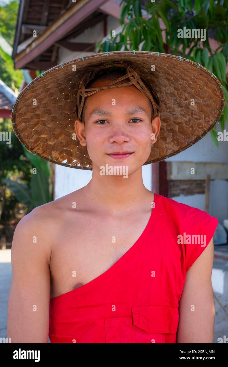 Laos, Luang Prabang, a UNESCO World Heritage Site, young monk at the Vat That Luang ...