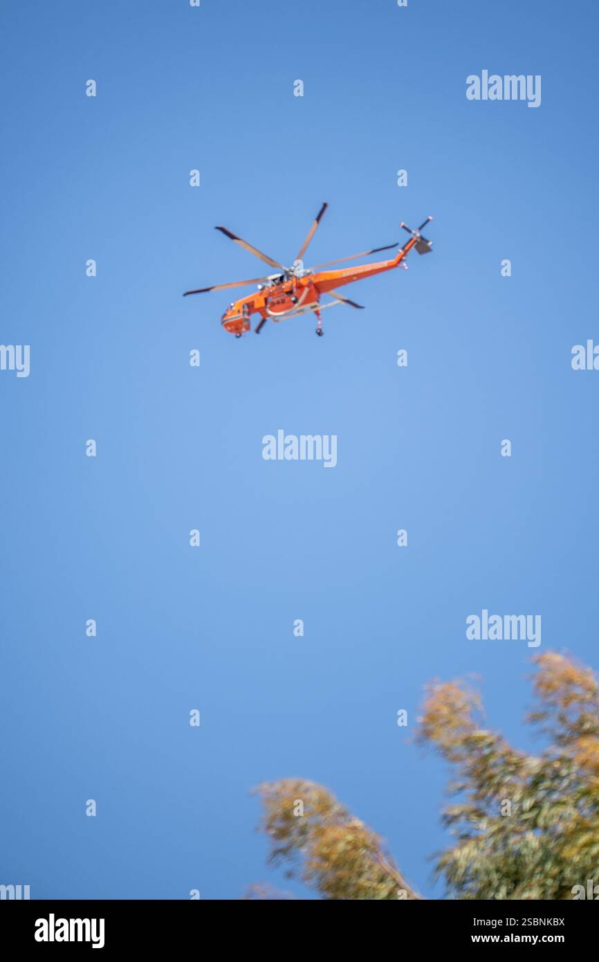 A firefighting helicopter returns from the fire zone, after aiding ...