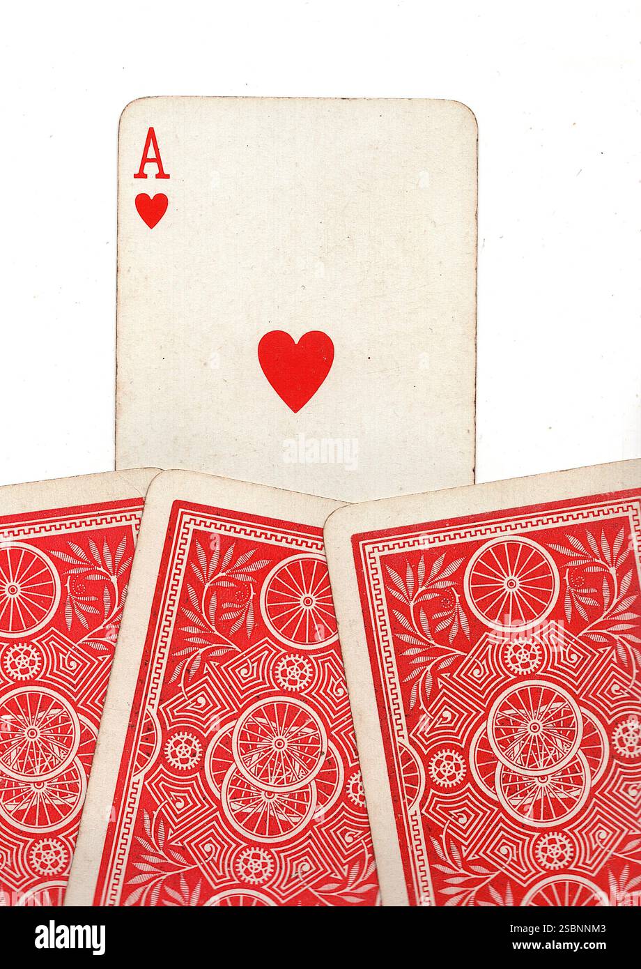 A montage of vintage playing card backs with the ace of hearts revealed ...