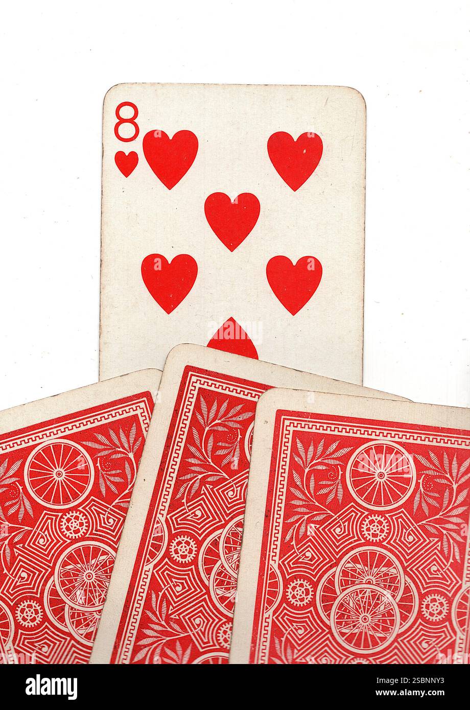 A montage of vintage playing card backs with the eight of hearts ...