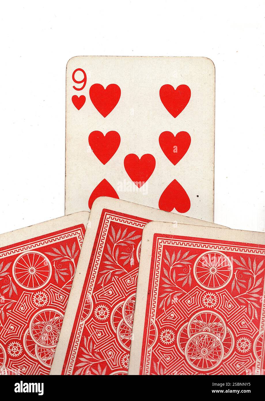 A montage of vintage playing card backs with the nine of hearts ...