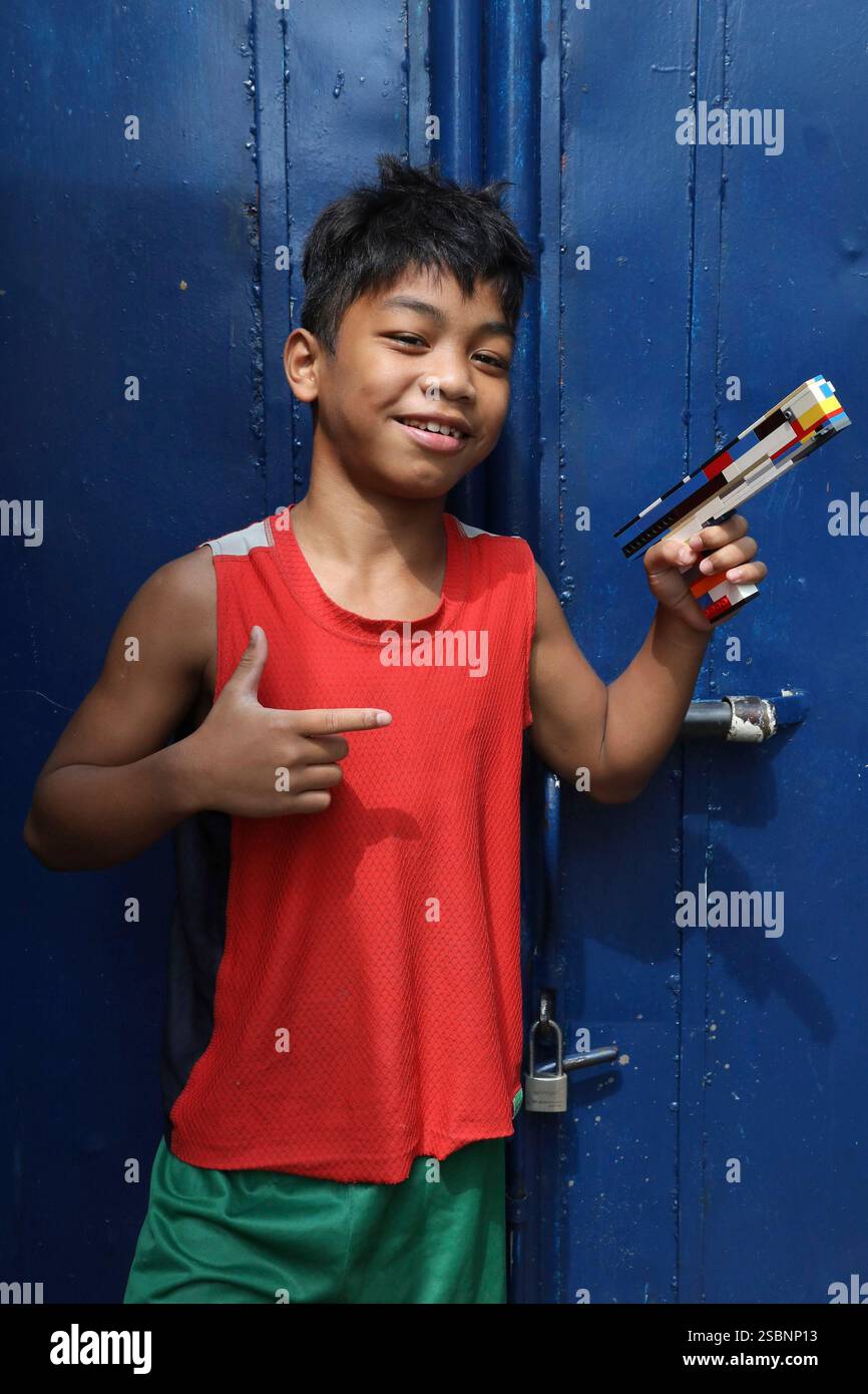 Philippines, Manila, child with a Lego gun in the Anak-Tnk foundation’s ...