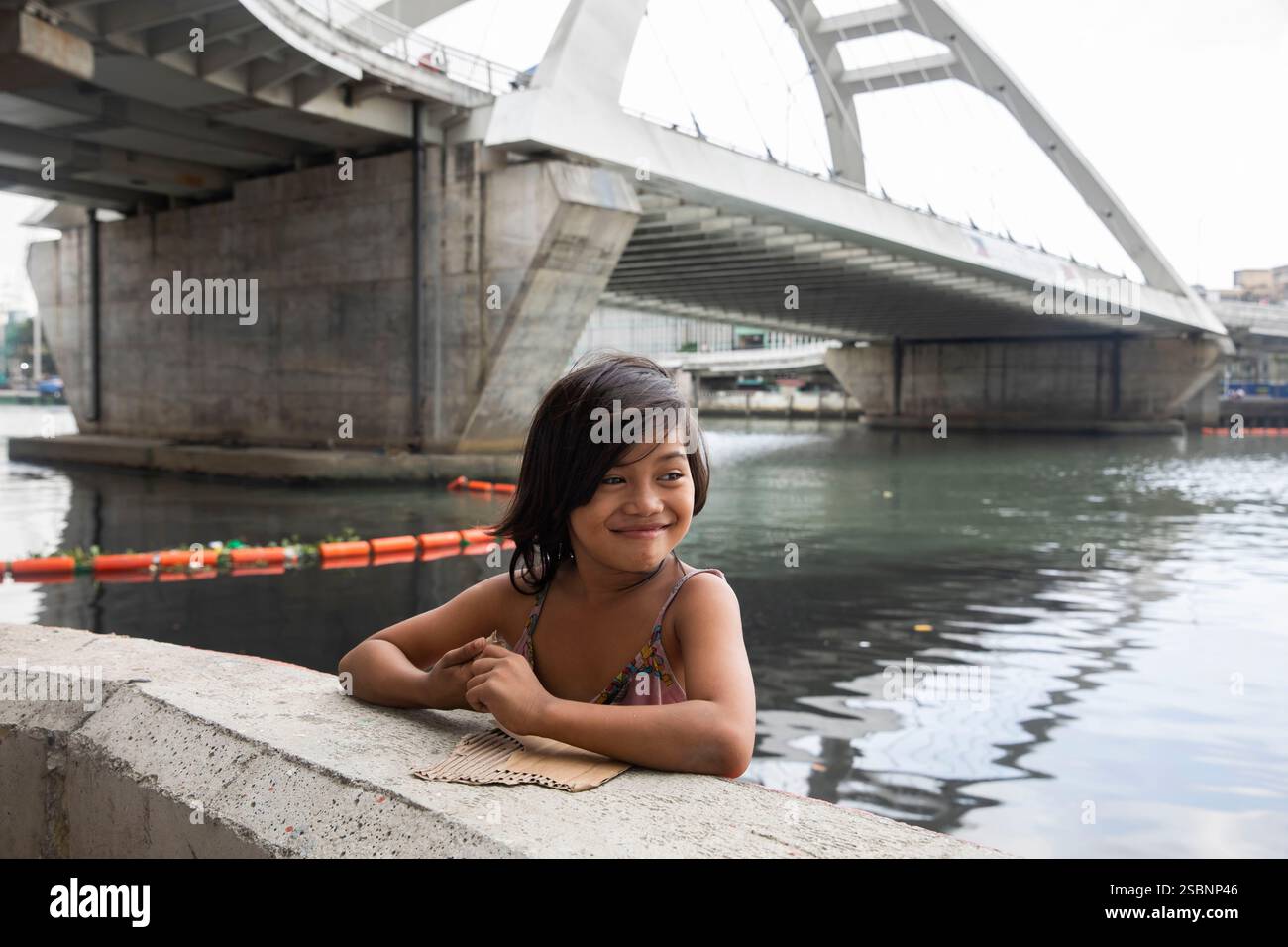 Philippines, Manila, girl living on the street met alongside a canal ...