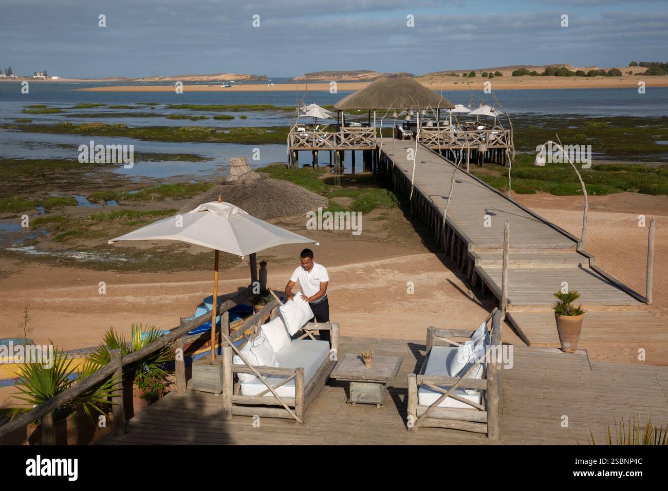 Morocco, Sidi Bennour province, Oualidia, waiter on a terrace of the ...