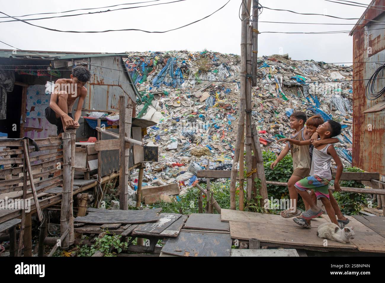 Philippines, Manila, Malabon, children walking in a slum in front of a bubbish dump Stock Photo ...