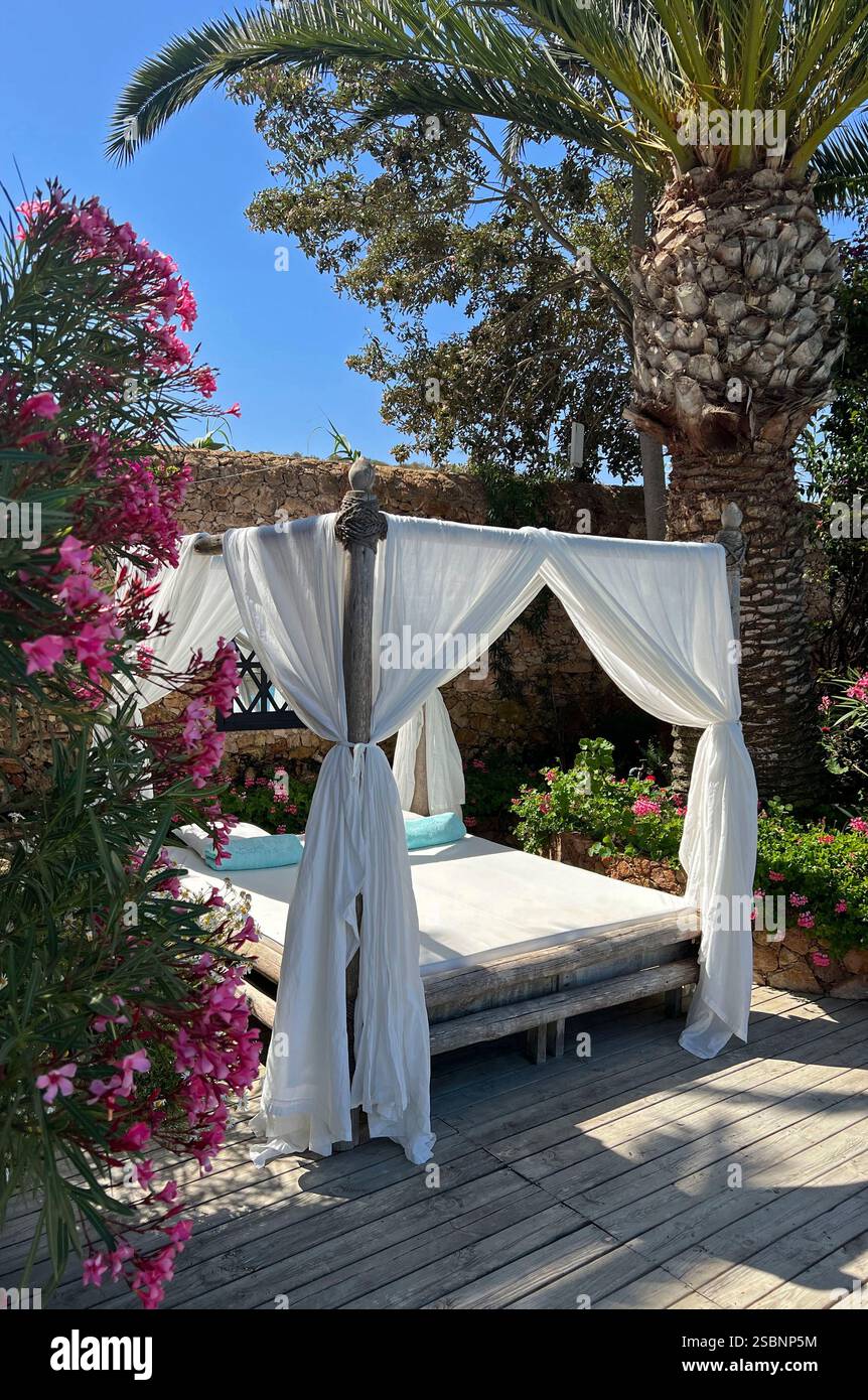 Morocco, Sidi Bennour province, Oualidia, canopy bed in the pool garden ...