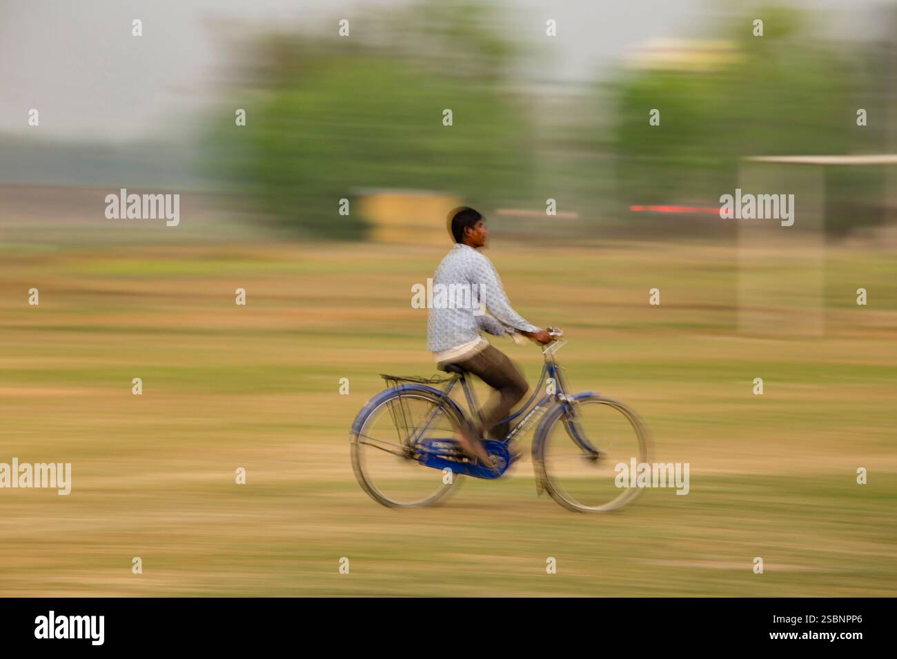 Nepal, Chitwan, Sauraha, man riding a bicycle Stock Photo - Alamy