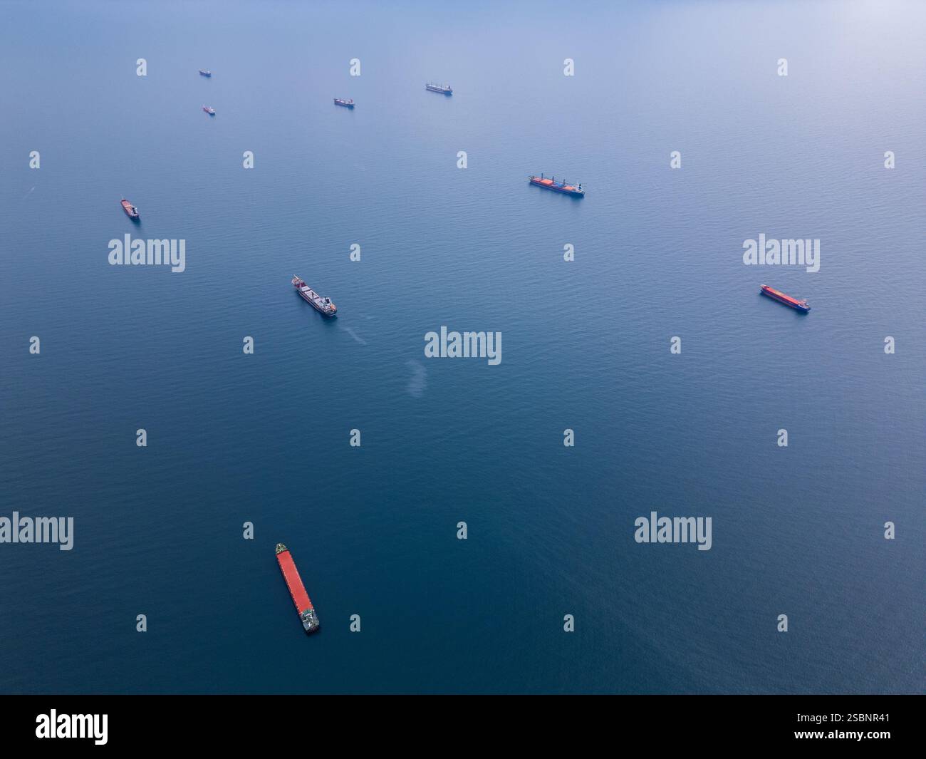 An aerial perspective of cargo ships floating on the open sea ...