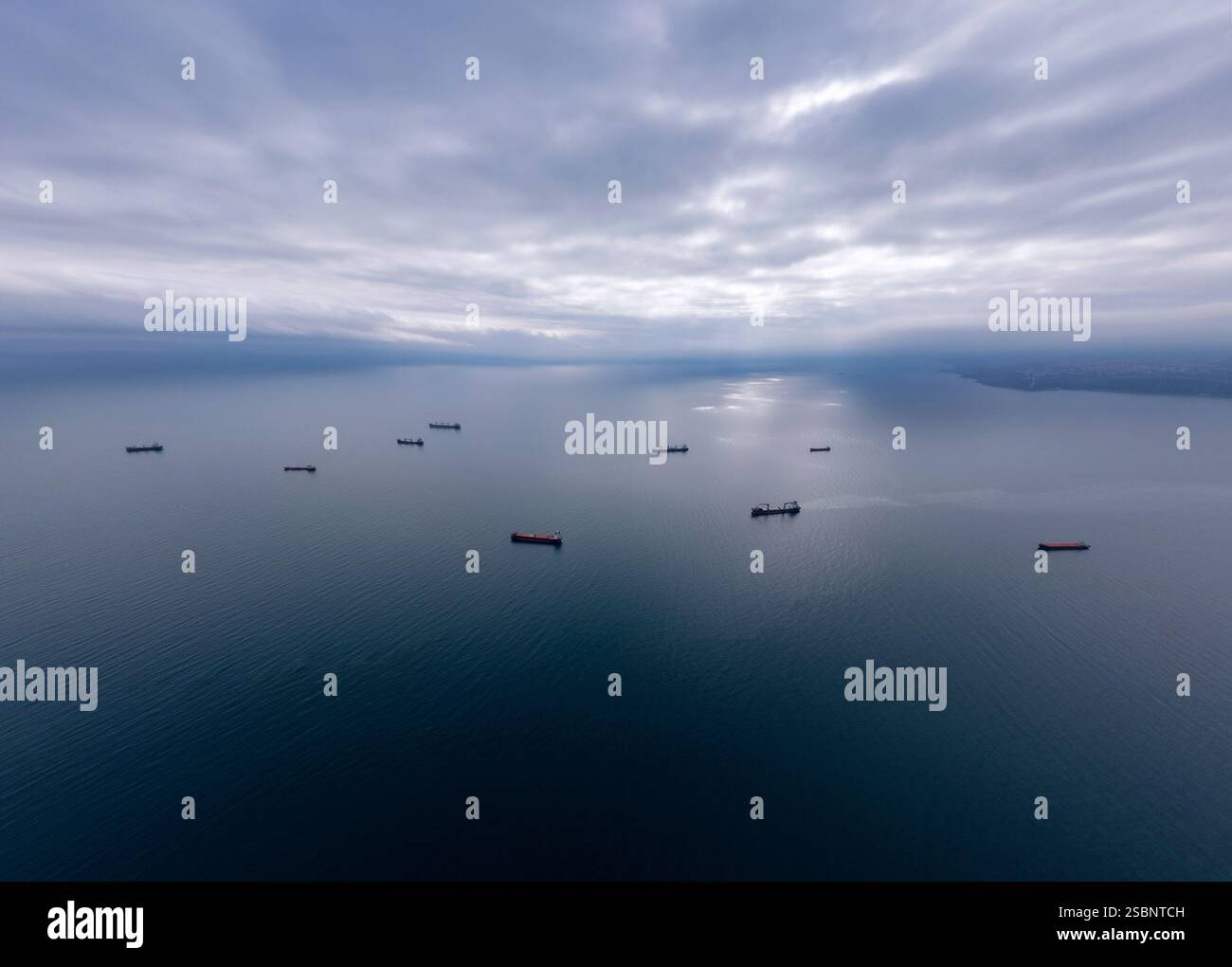 An aerial perspective of cargo ships floating on the open sea ...