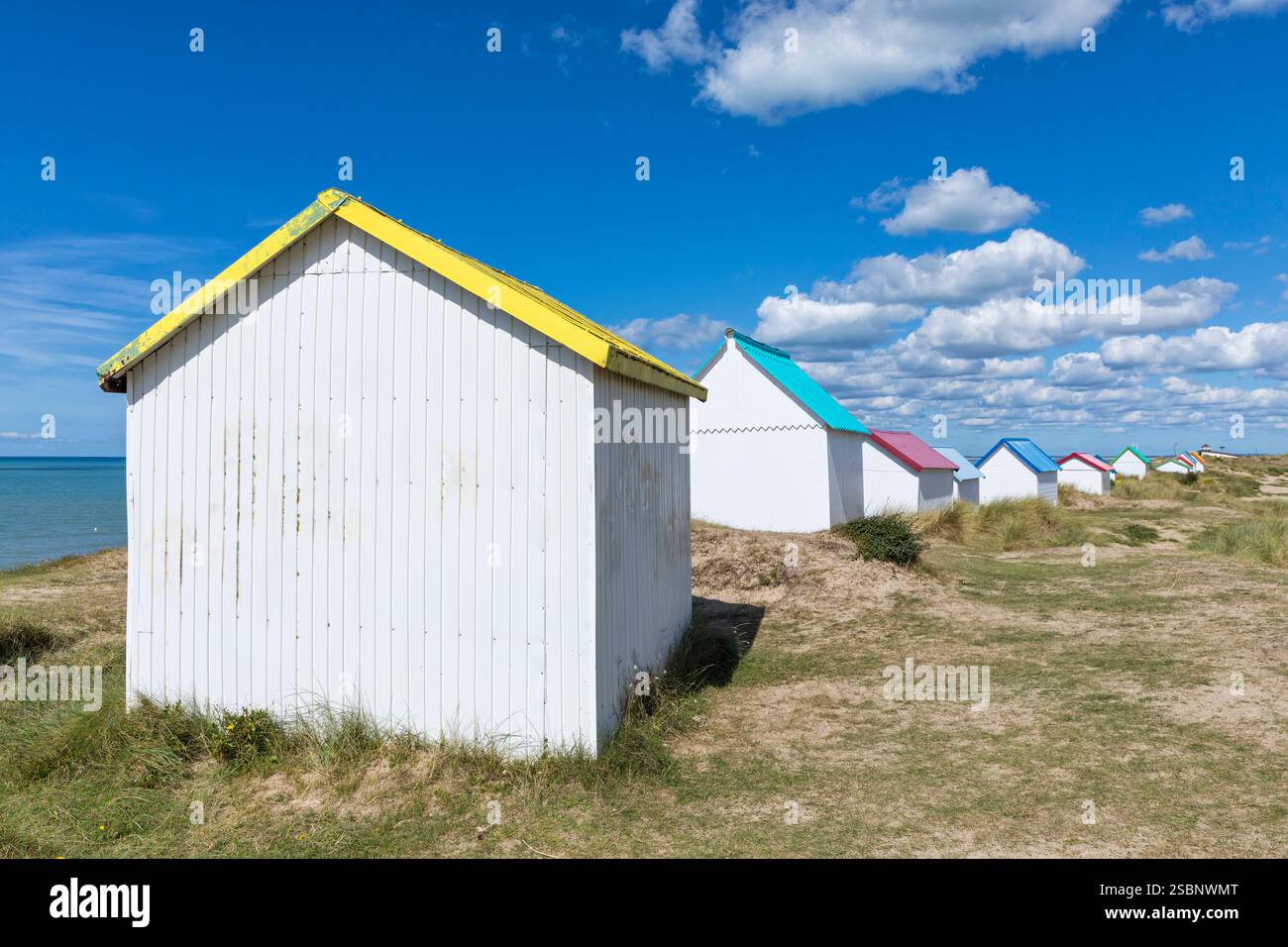 Famous beach cabins with their colorful roofs in the dunes of Gouville ...