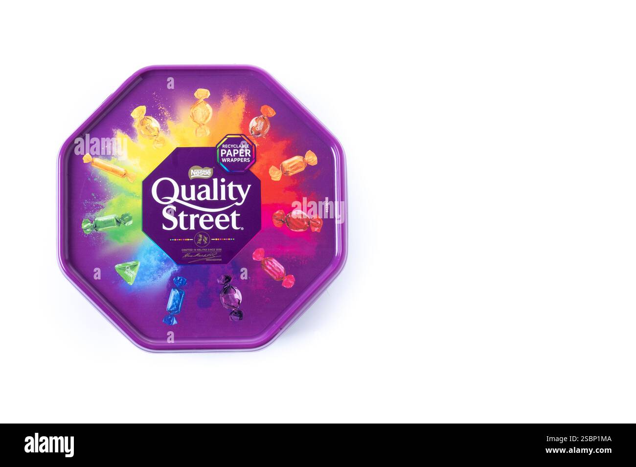 Quality Street chocolate box on yellow and purple background Stock ...