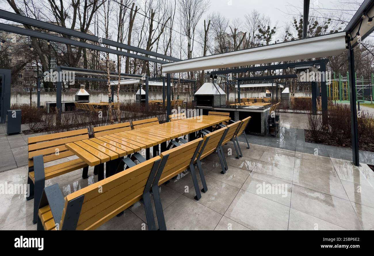 Beautiful backyard with barbeque area and dining table Stock Photo - Alamy