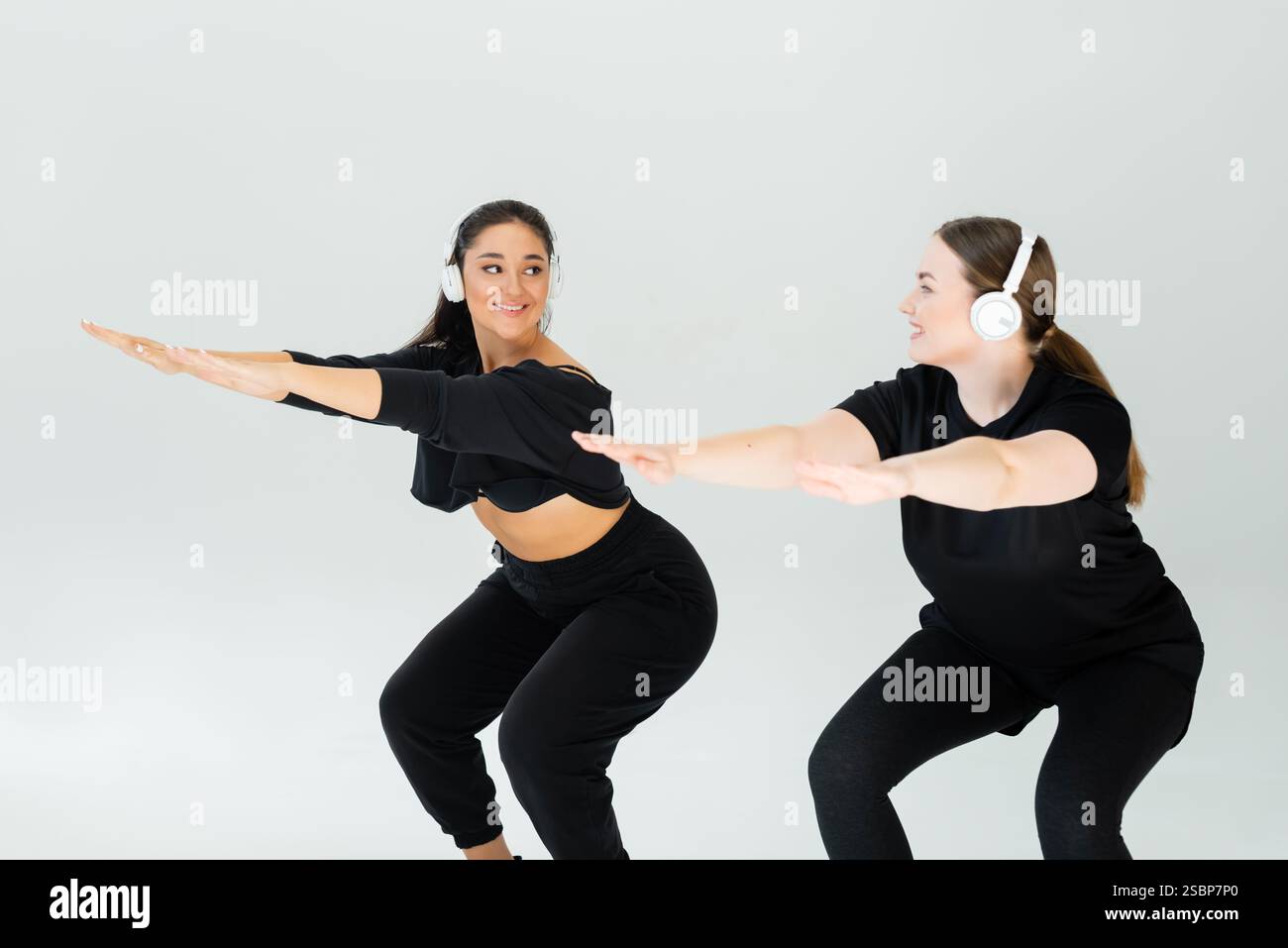 Two women perform synchronized workout hi-res stock photography and ...