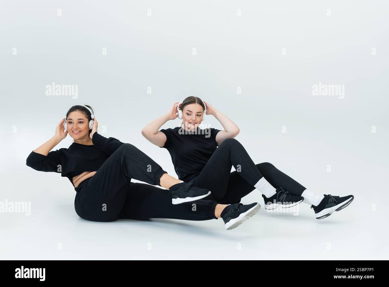 Two fit women enjoy a fun and energetic workout while wearing stylish ...