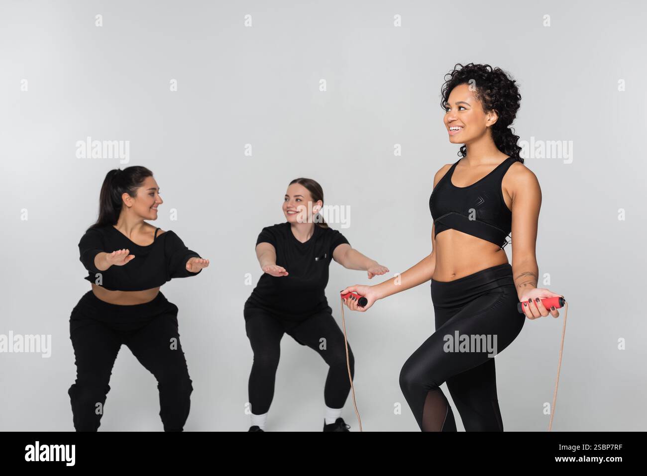 Three women showcase strength and teamwork while exercising with jump ...