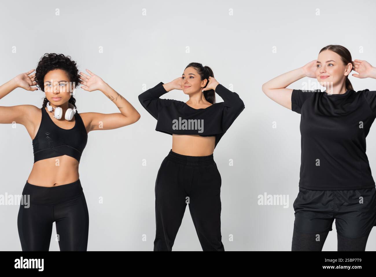 Three strong women exhibit confidence and camaraderie while engaging in ...