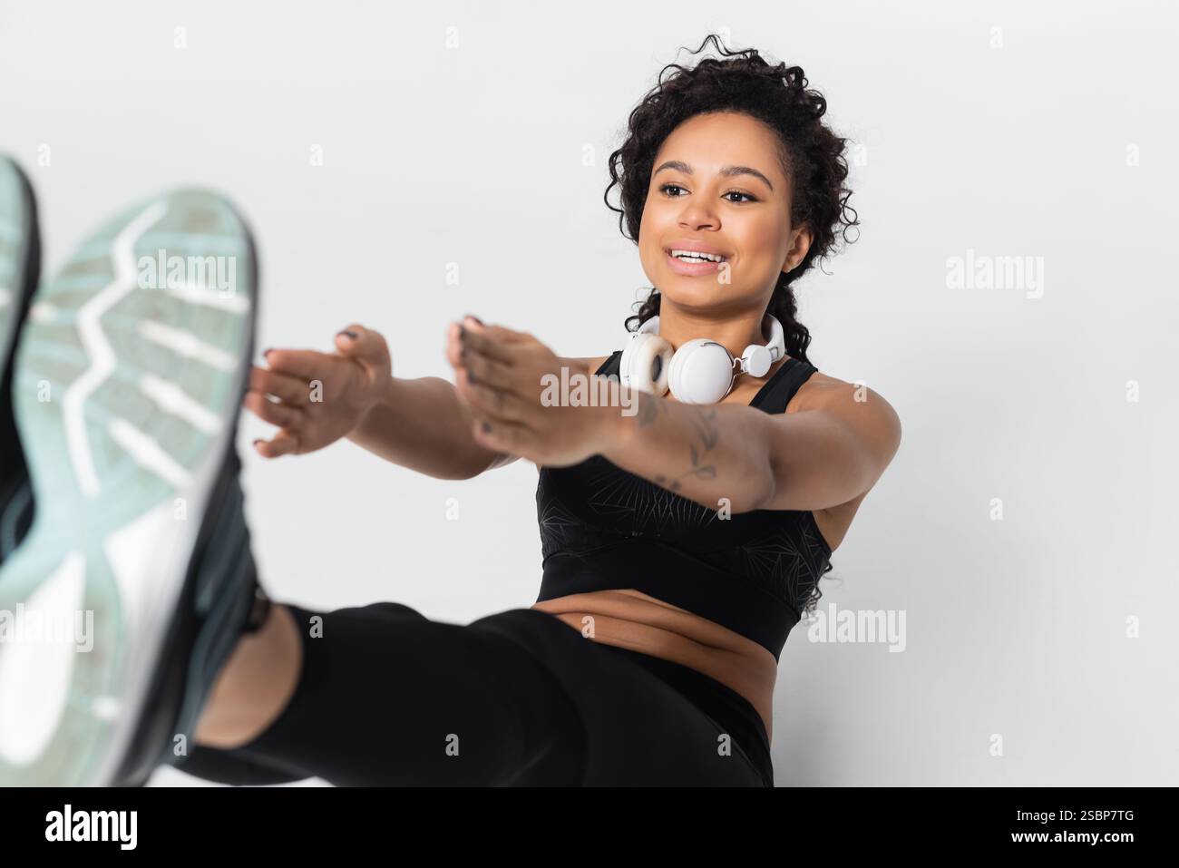 A fit woman showcases her strength while engaging in fitness activities ...