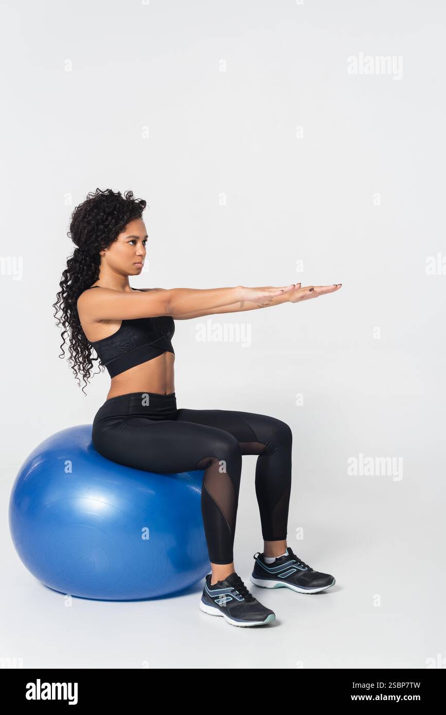 A fit woman engages in a workout session demonstrating balance and ...
