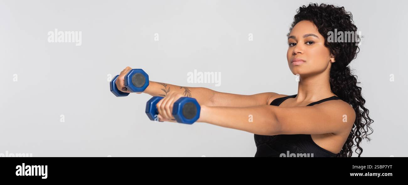 Strong female athlete engages in a fitness routine, showcasing her ...