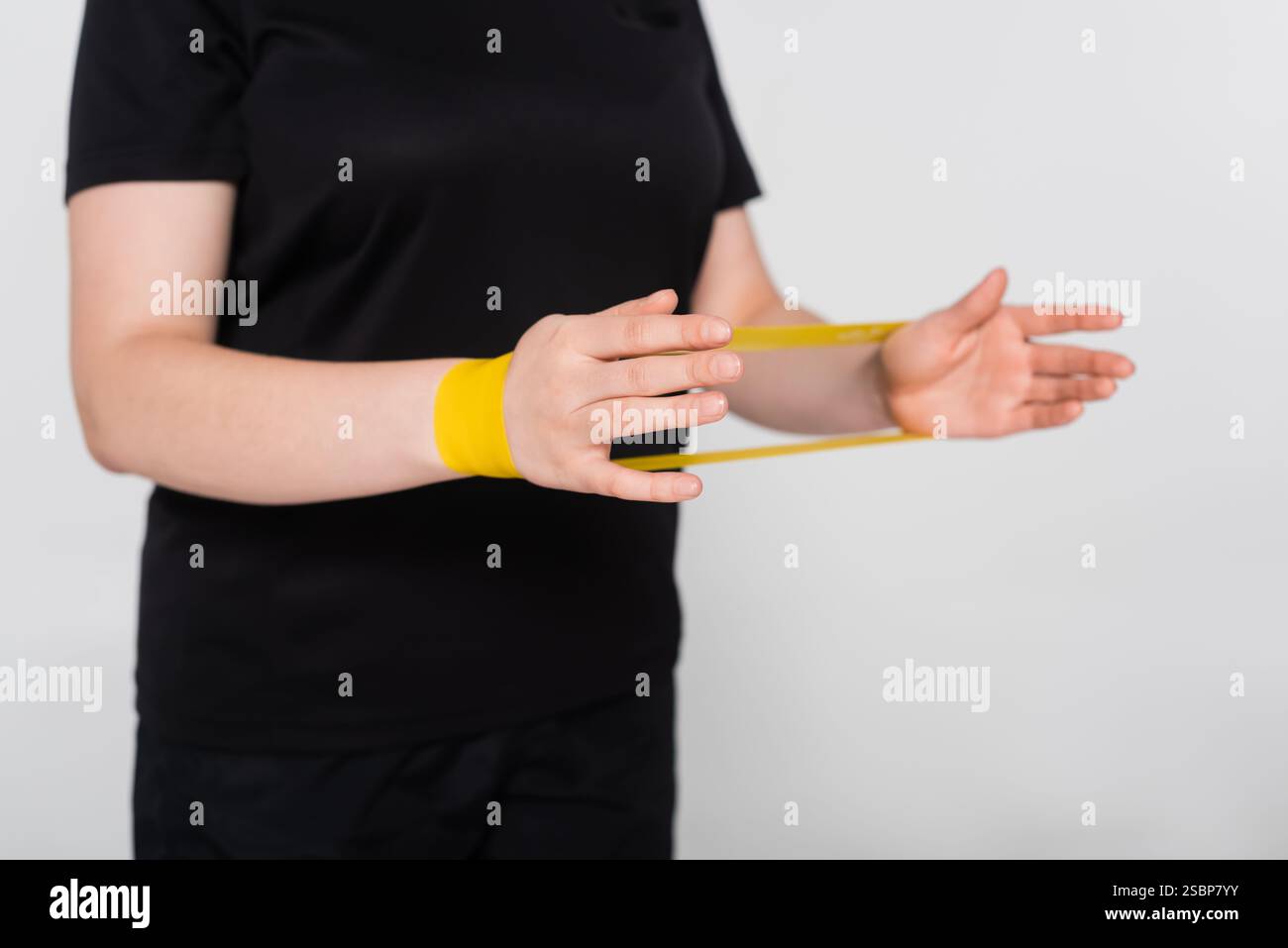 Strong female engages in an empowering workout using a resistance band ...