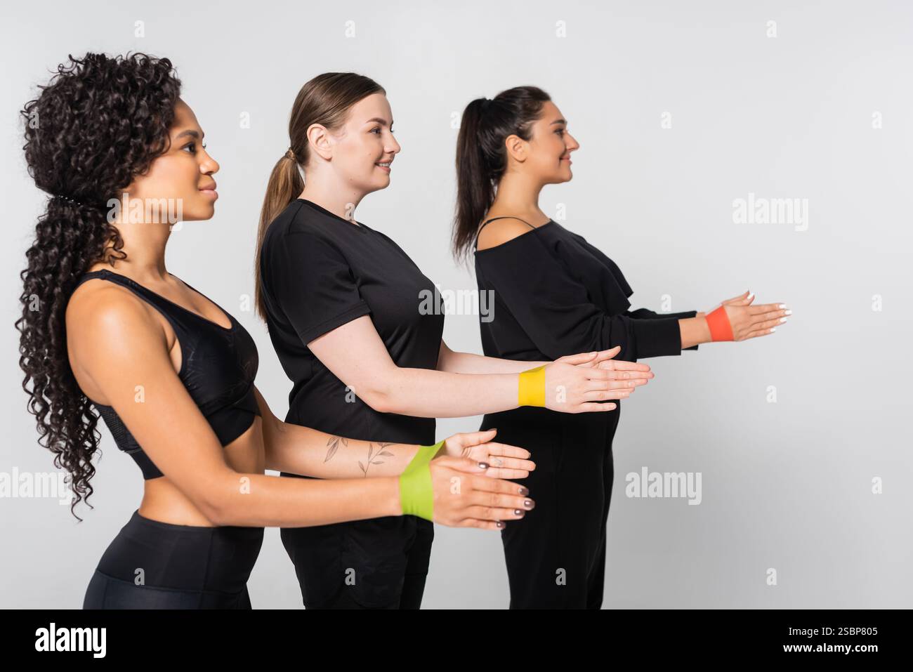 Three fit women perform a synchronized fitness exercise, embodying ...