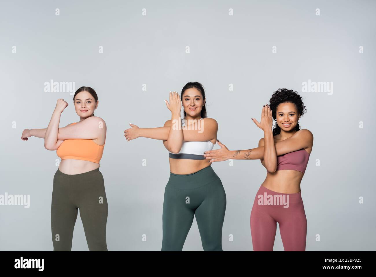 Three strong and fit women showcase their athleticism while enjoying a ...