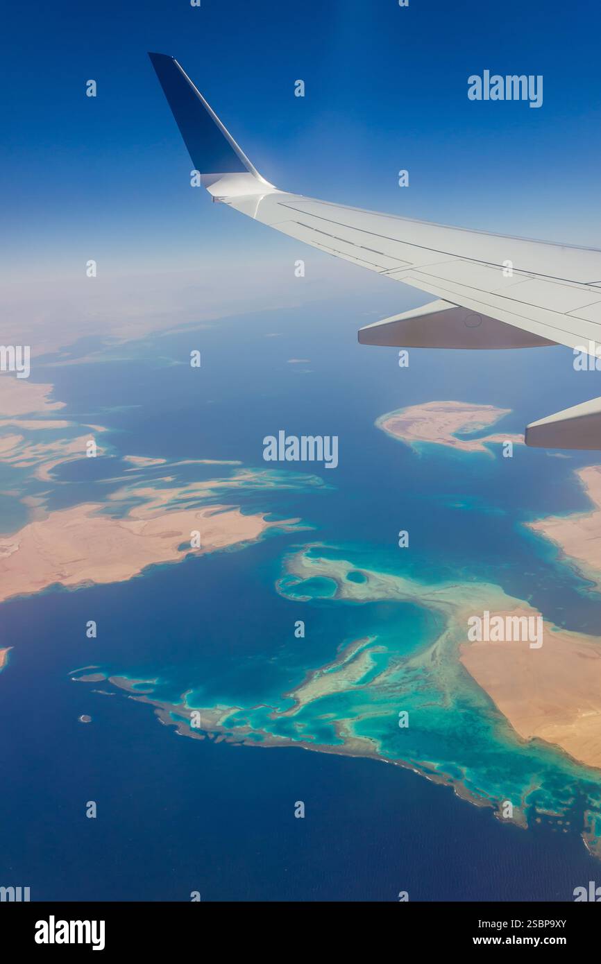 View from a plane window on the wing and the landscape below it Stock ...